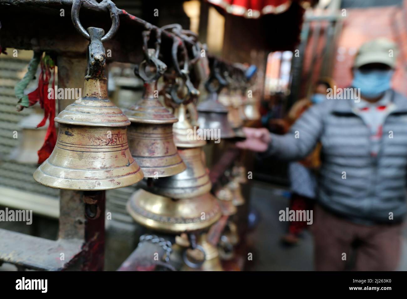 Hand of a nepali man ringing a sacred bell in a Kathmandu temple Stock ...