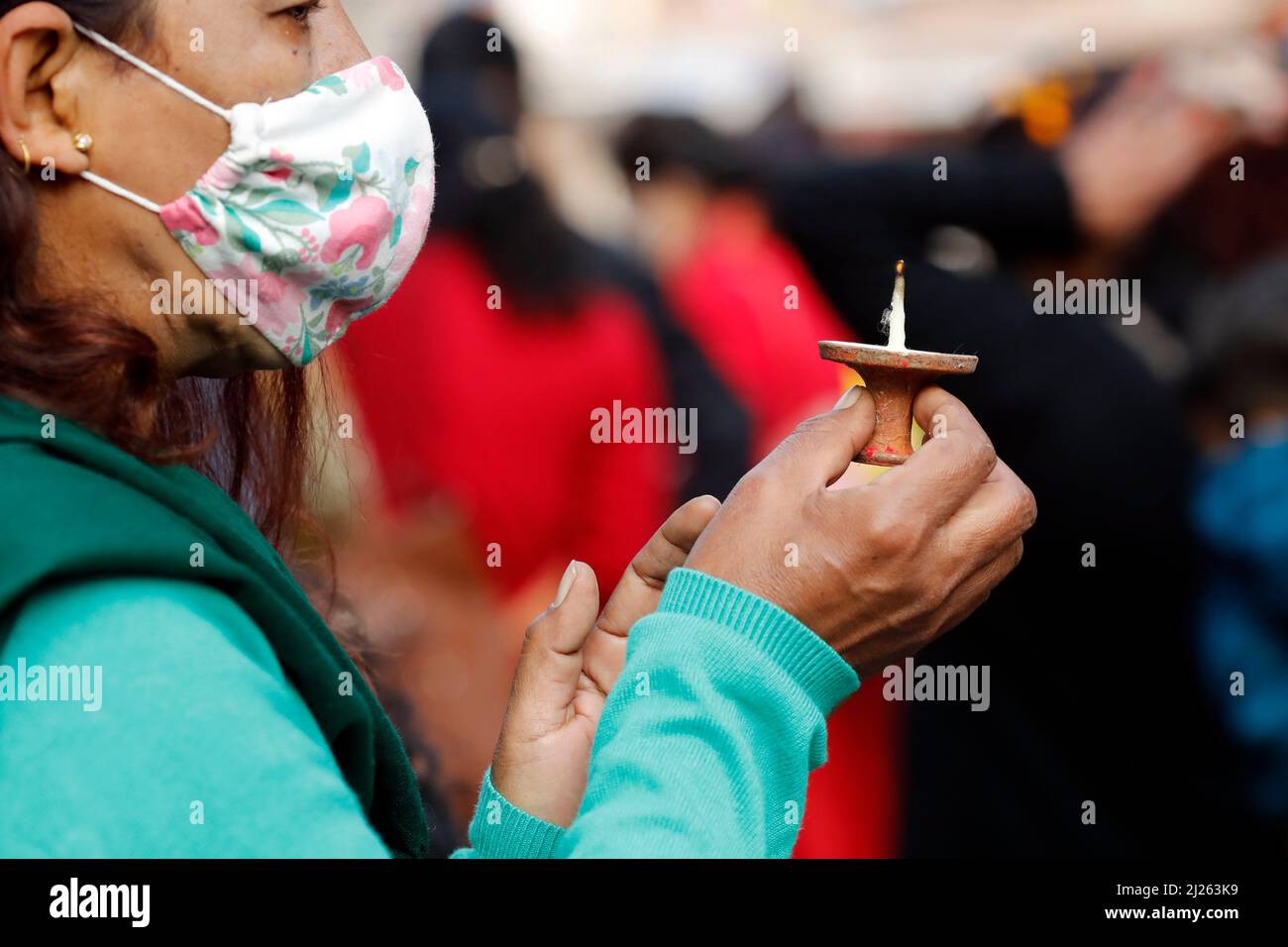 Woman praying oil lamp in hi-res stock photography and images - Alamy