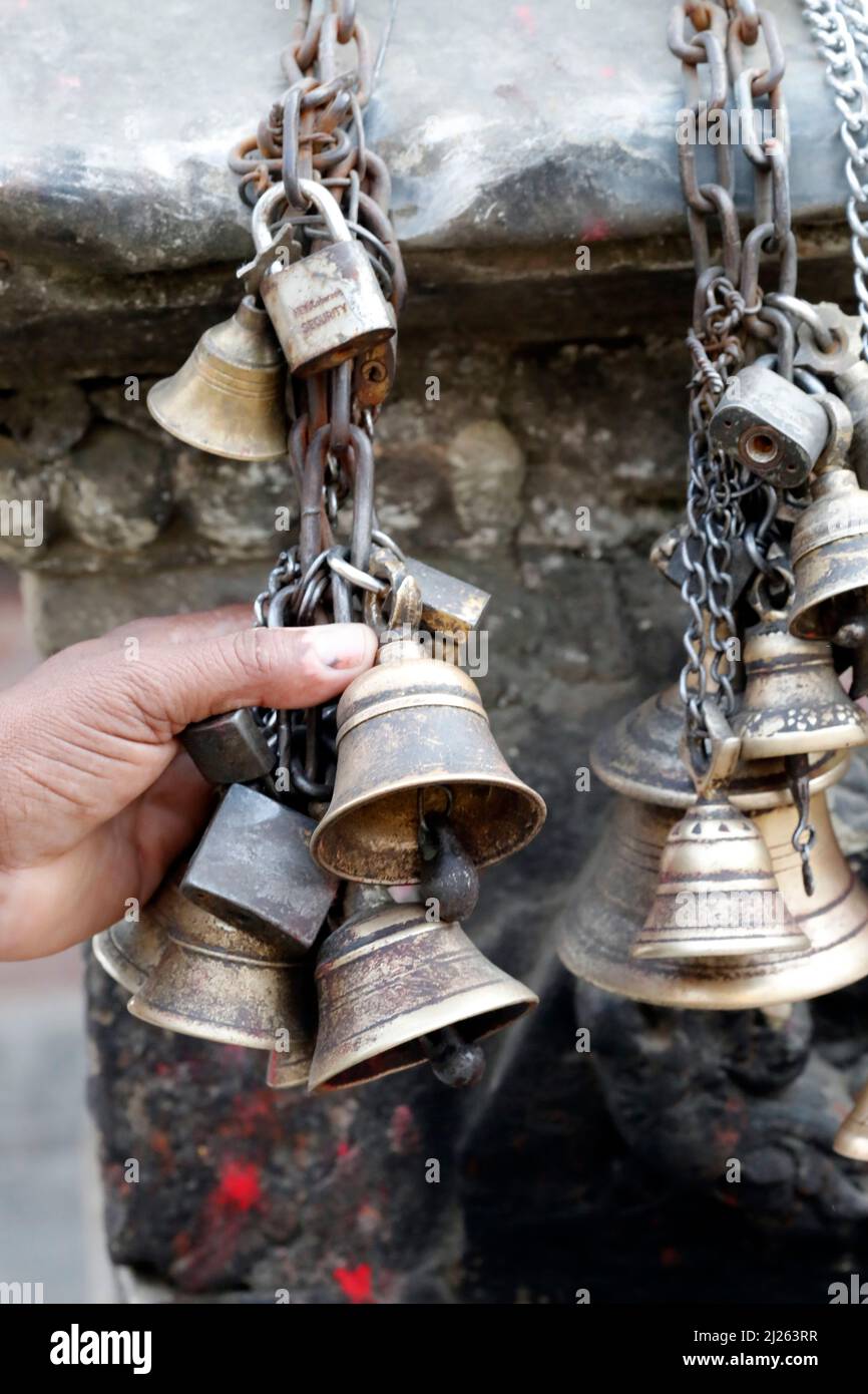 Hand of a nepali man ringing a sacred bell in a Kathmandu temple Stock ...
