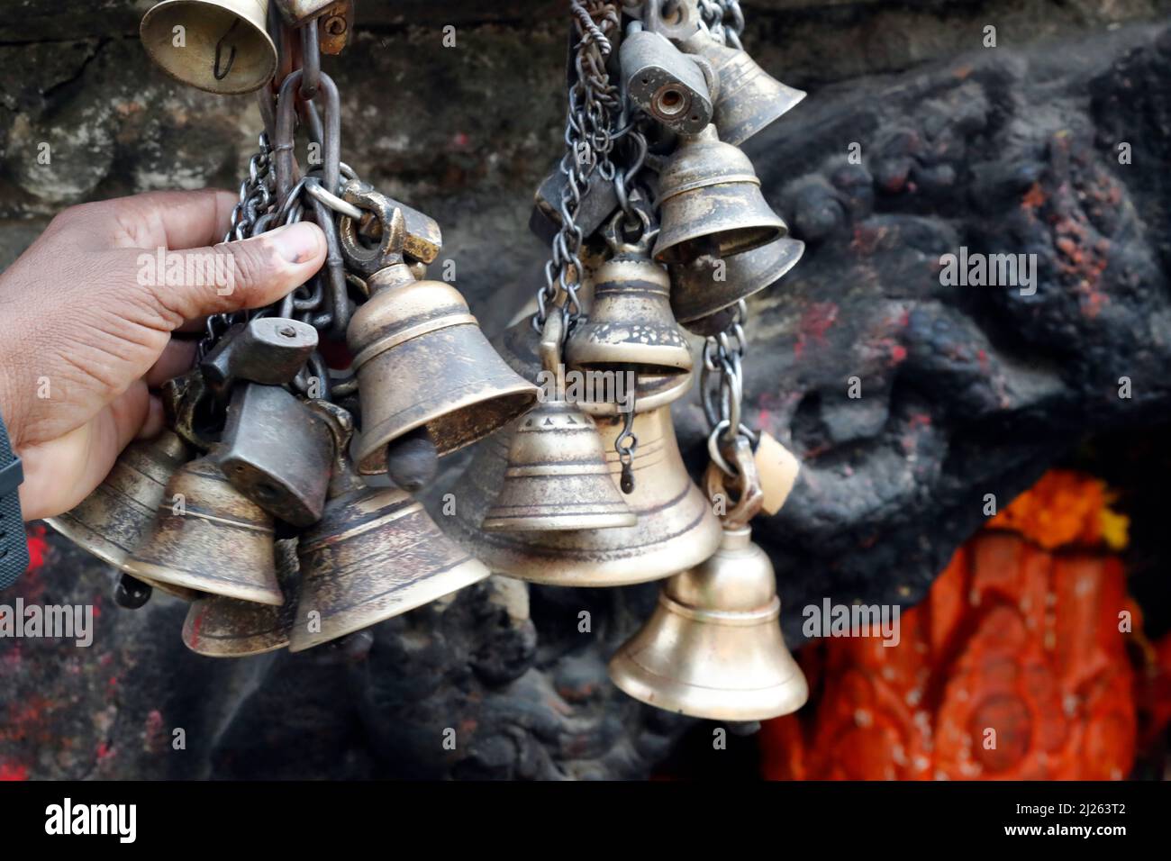 Hand of a nepali man ringing a sacred bell in a Kathmandu temple Stock ...
