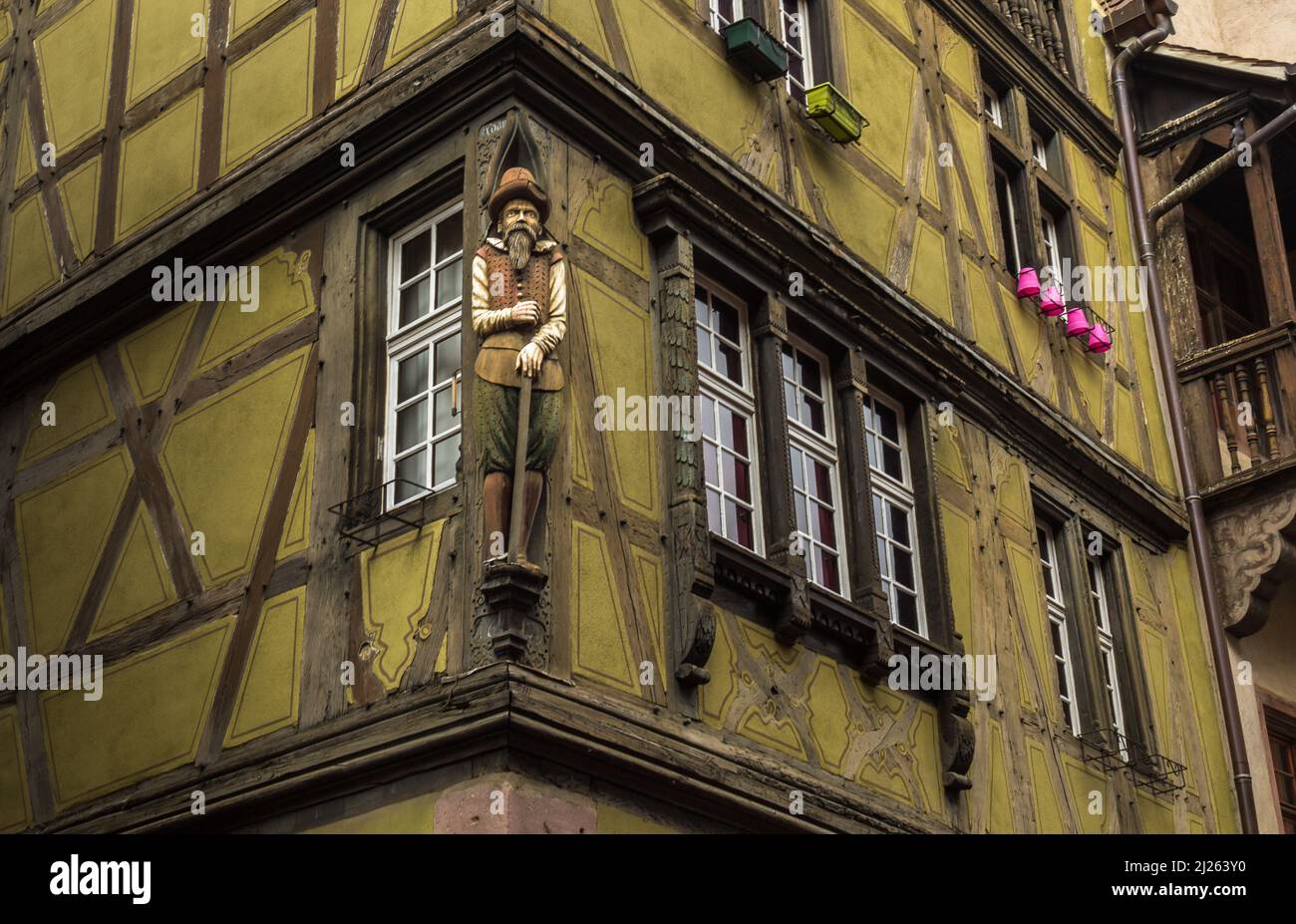 Half timbered house in Colmar with statue Stock Photo - Alamy