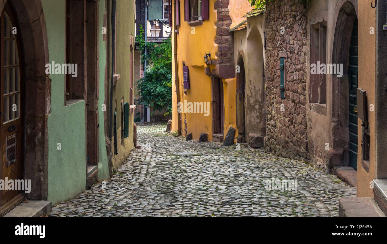 An ancient alley with cobblestones and old houses Stock Photo - Alamy