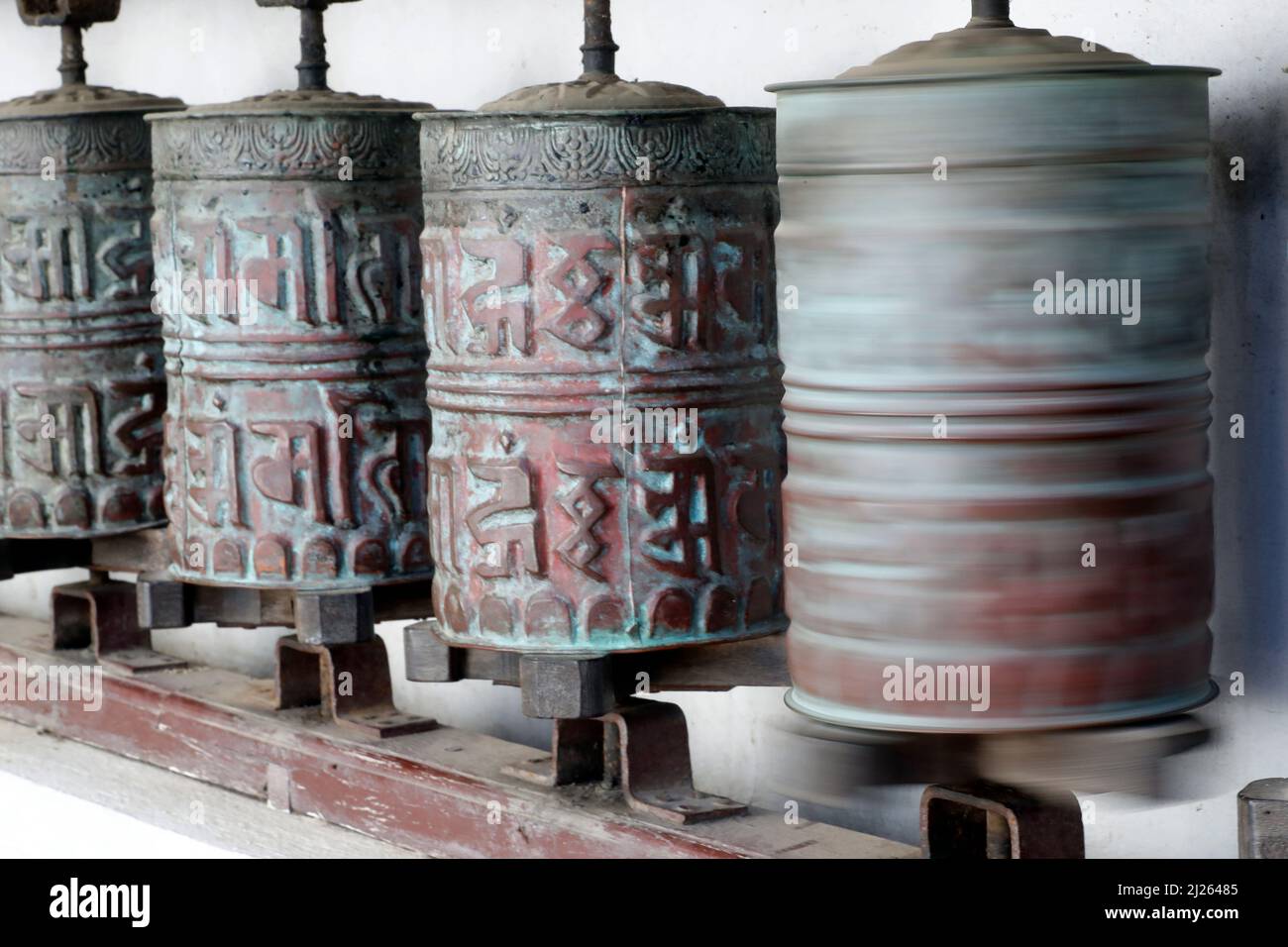 Pema Osel Ling Monastery. Rolling metal prayer wheels circling. A ...