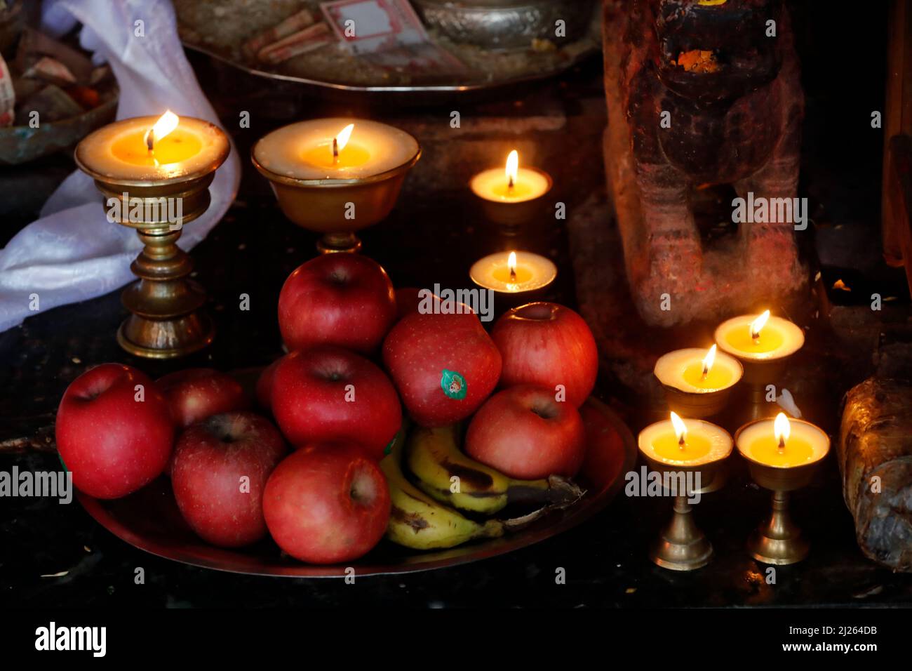 Ganesh Saraswati buddhist temple. Offerings. Apples and butter lamps ...