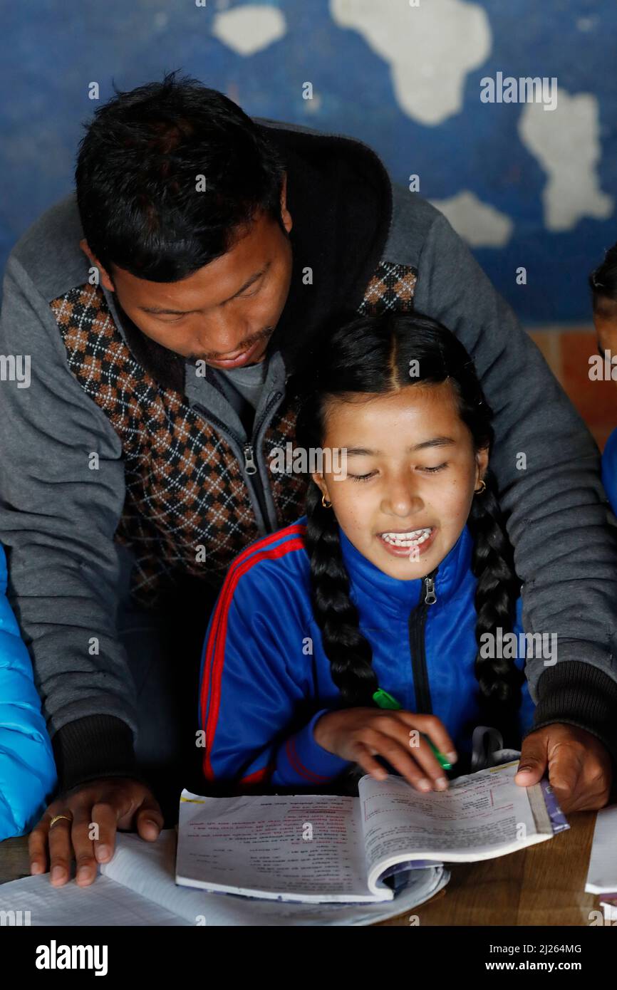 Secondary school. Pupil in classroom with teacher Stock Photo - Alamy