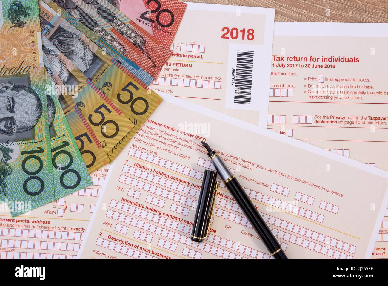 Australian tax form with colorful australian dollar banknotes close up ...