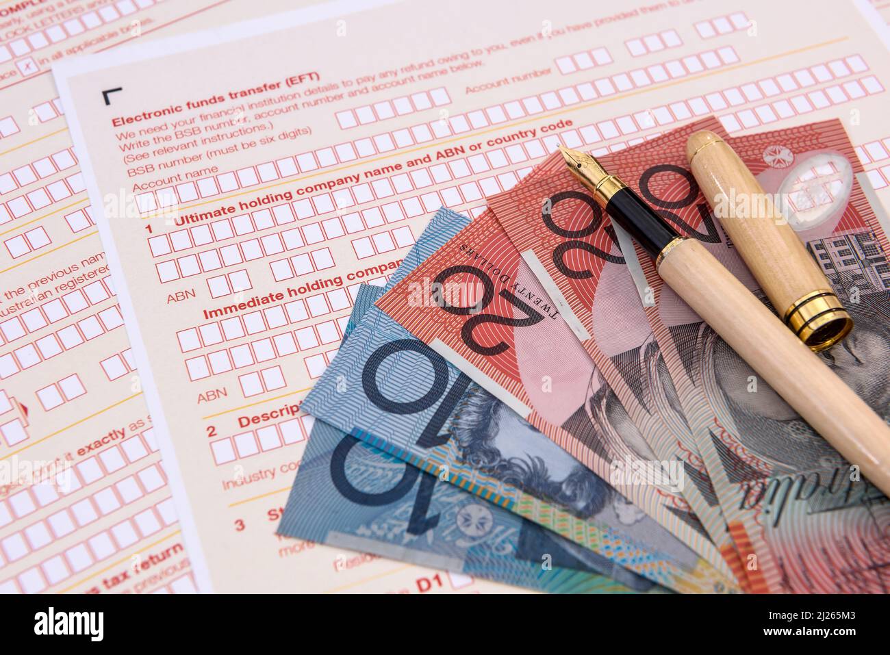 Australian tax form with colorful australian dollar banknotes close up ...