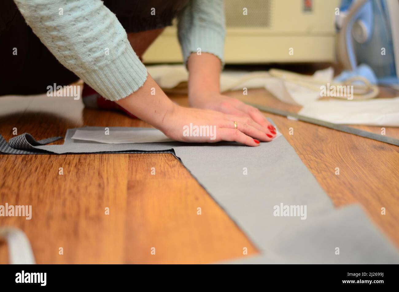 Top view of tailor hands working with scissor and suit textile cloth ...
