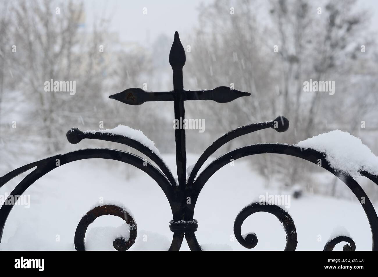 Detail of a wrought iron fence with cross Stock Photo - Alamy