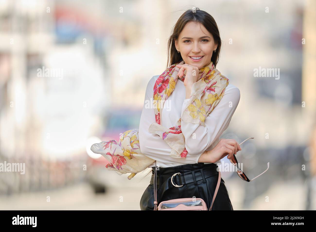 Beautiful young lady with long healthy hair and scarf on her neck ...