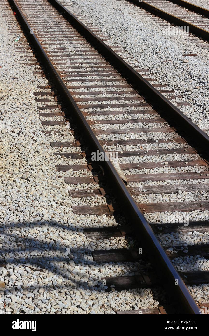 Railroad tracks at the local public train station Stock Photo - Alamy