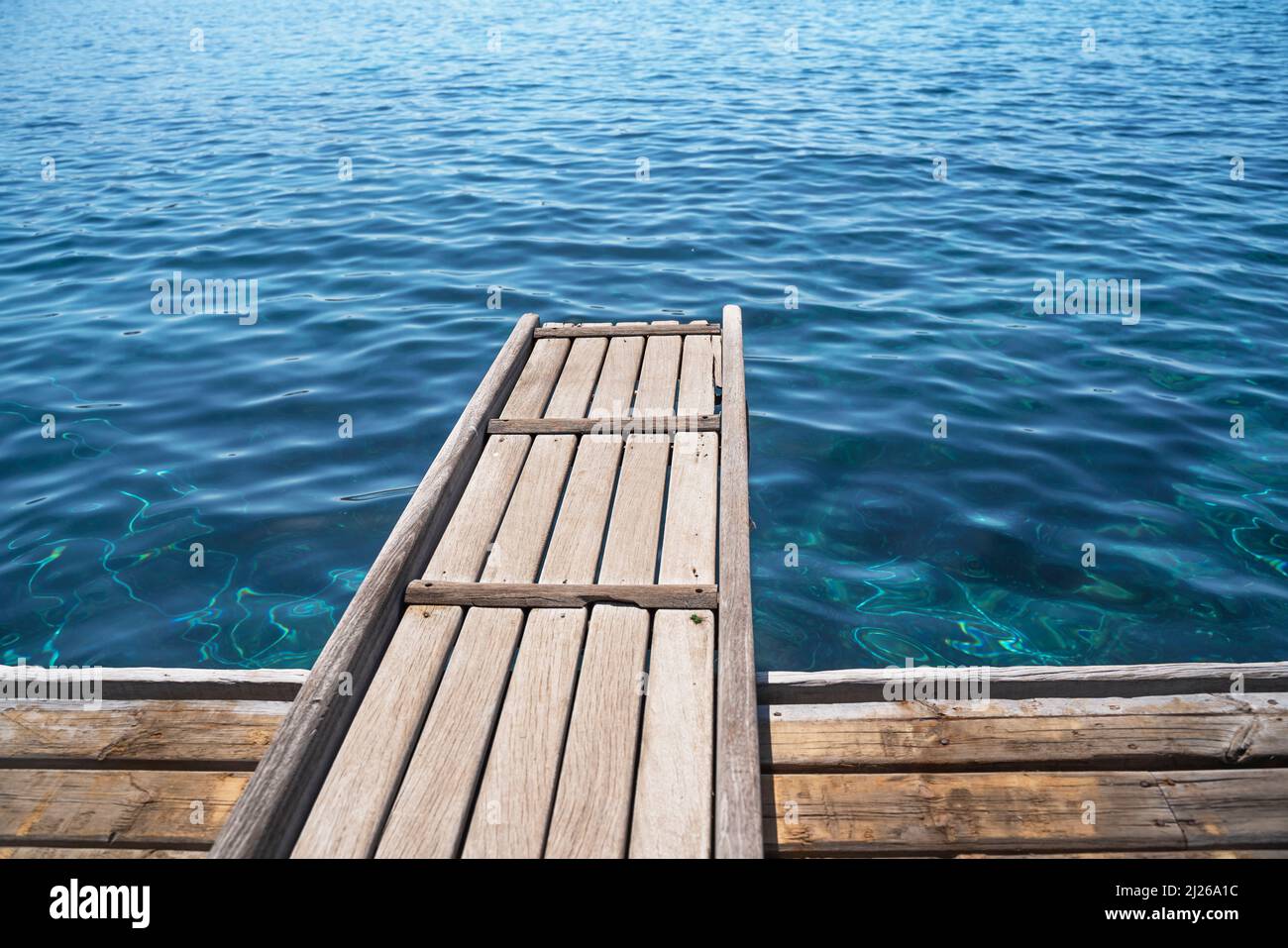 Empty wooden deck with the sea in the background Stock Photo - Alamy