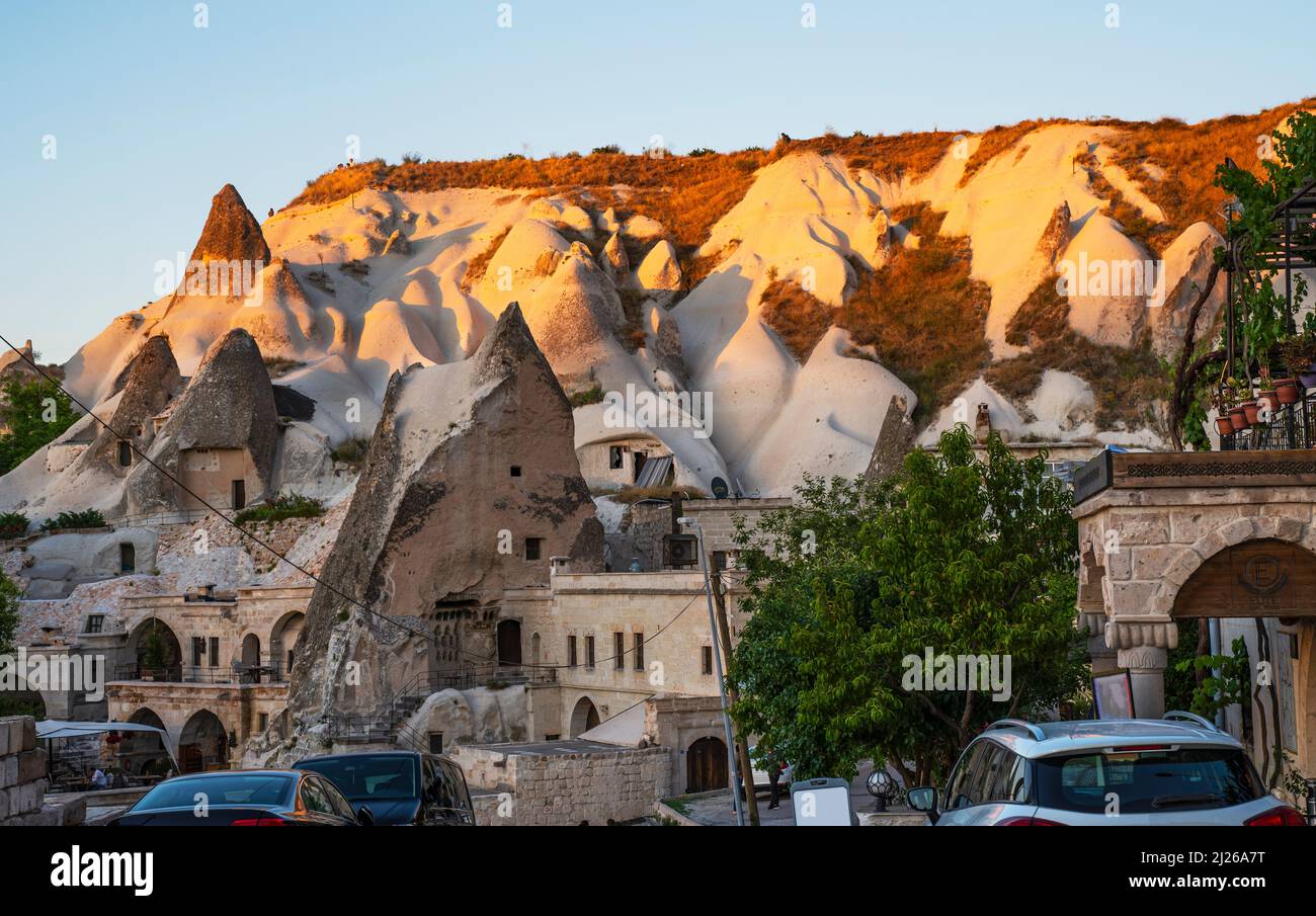Ancient stone dwellings at sunset in Goreme in Cappadocia, Turkey Stock ...