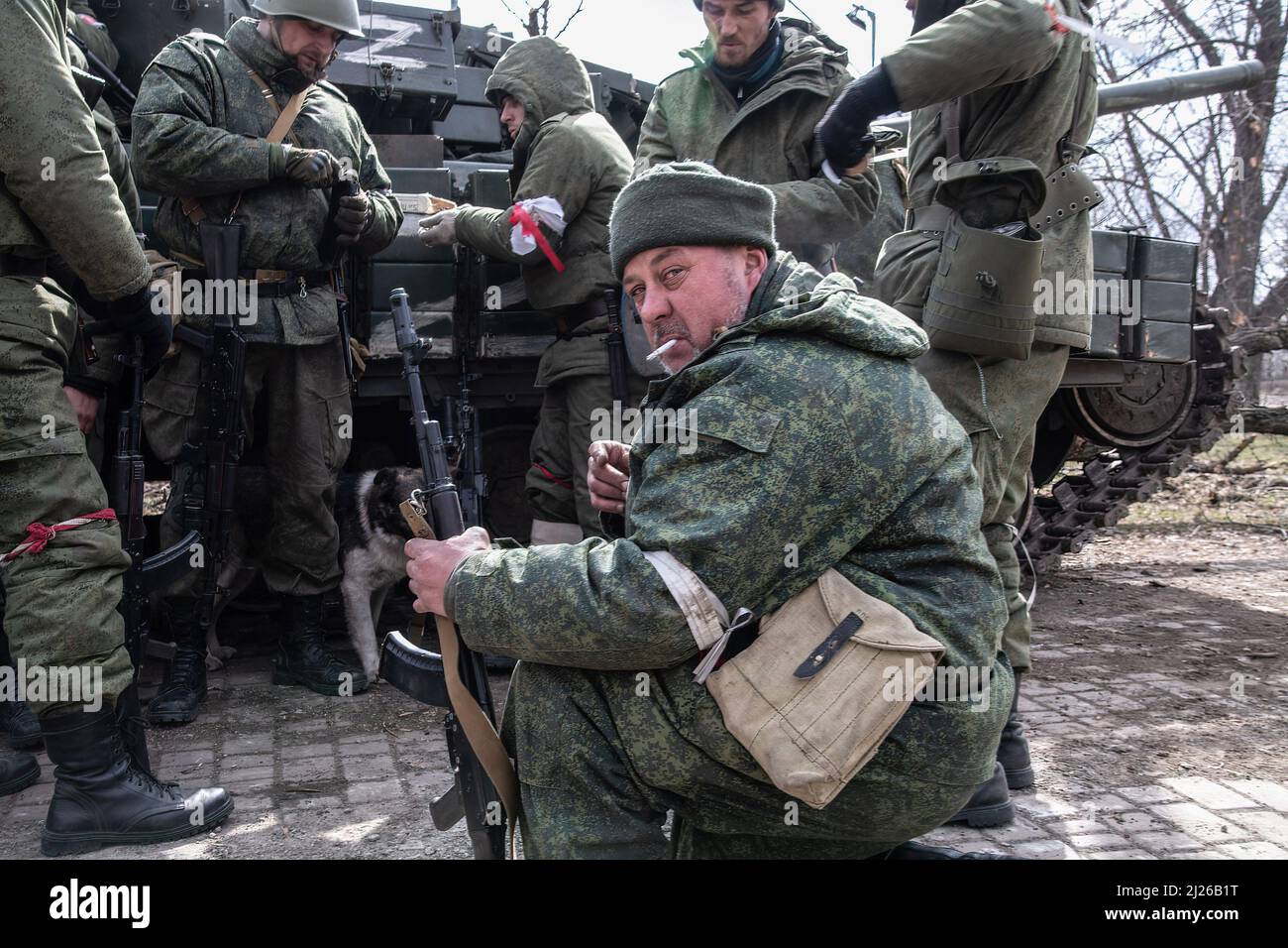 DNR (Donetsk People's Republic) fighters take cover behind an abandoned ...