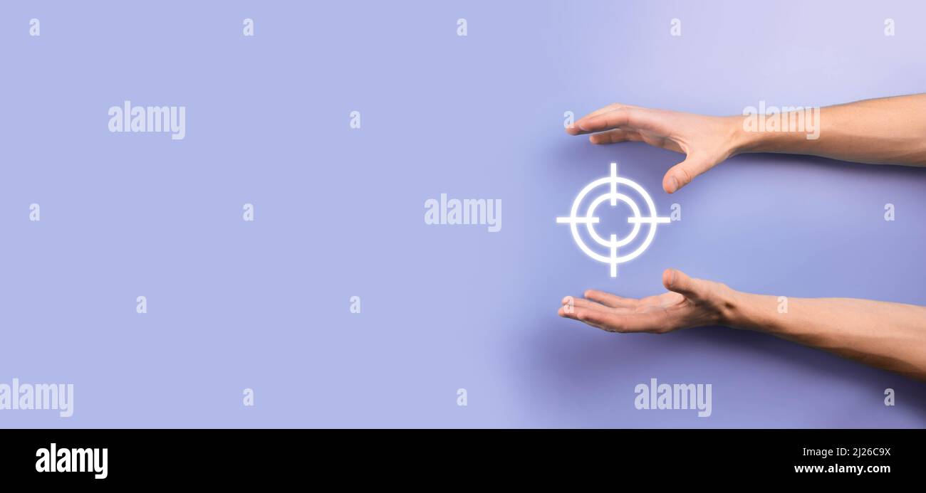 Targeting concept with businessman hand holding target icon dartboard ...