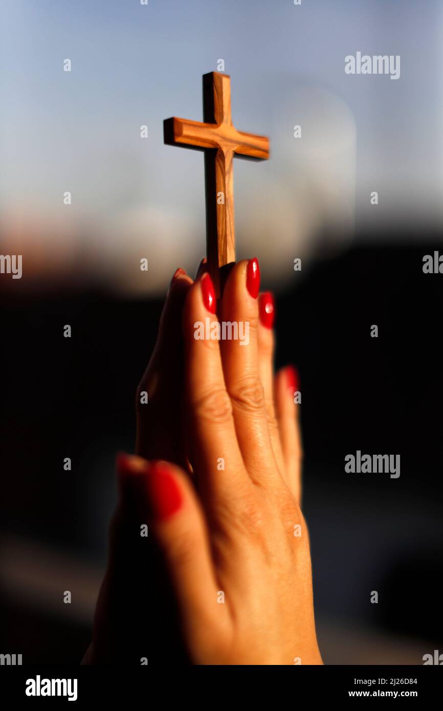 Woman hand wooden cross hi-res stock photography and images - Alamy