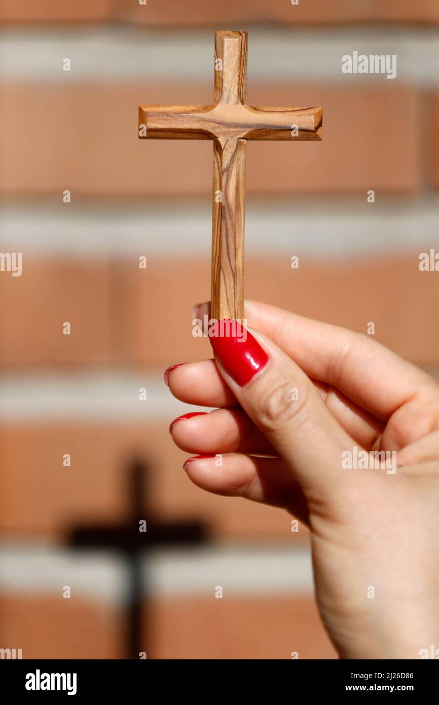 Woman hand wooden cross hi-res stock photography and images - Alamy
