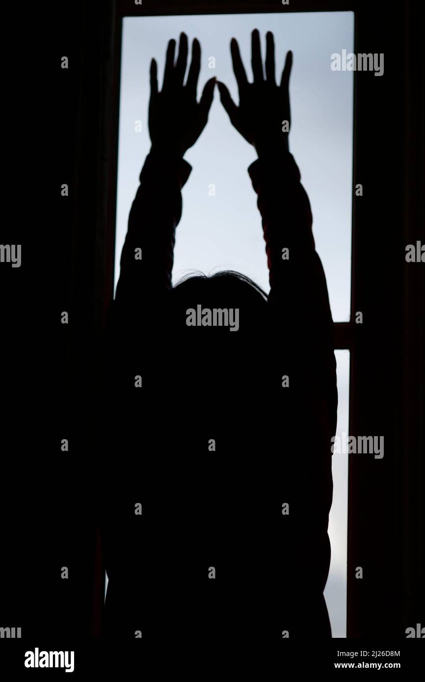 Silhouette of Woman Looking out of Window Stock Photo - Alamy