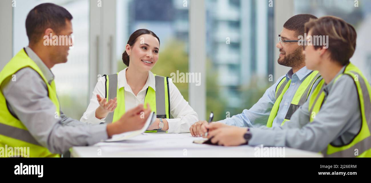 Lets talk construction. Cropped shot of a group of young construction ...