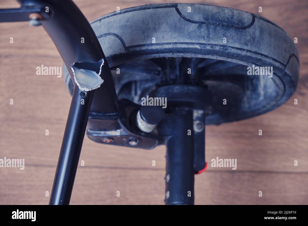 Broken chassis of a baby stroller, damage to the crossbar of the metal ...
