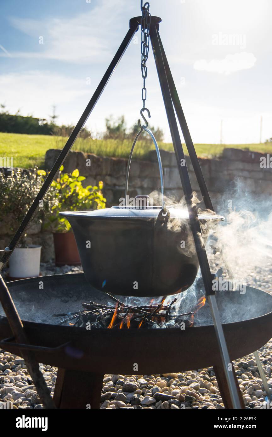 Cooking in the kettle over the fire bowl Stock Photo - Alamy
