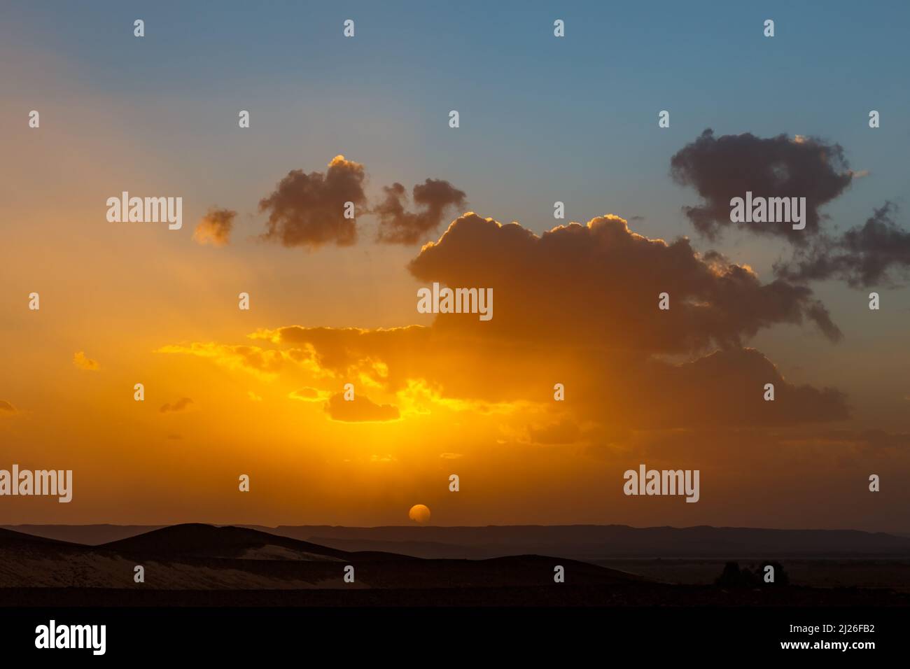 Sunset in the Sahara Desert. Beautiful sky. The sun is on the horizon ...