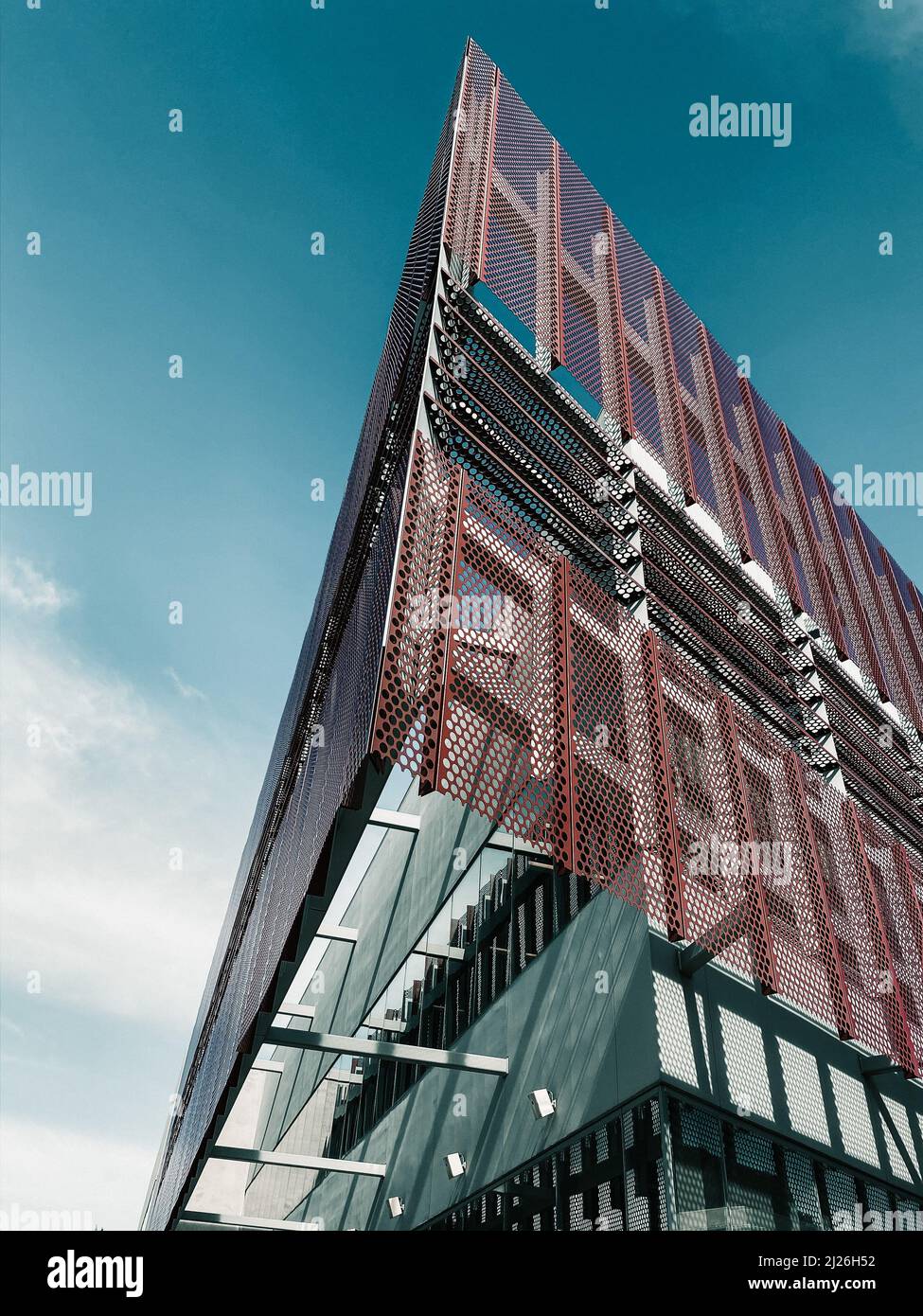 A low angle shot of RAW center triangle building under blue bright sky ...