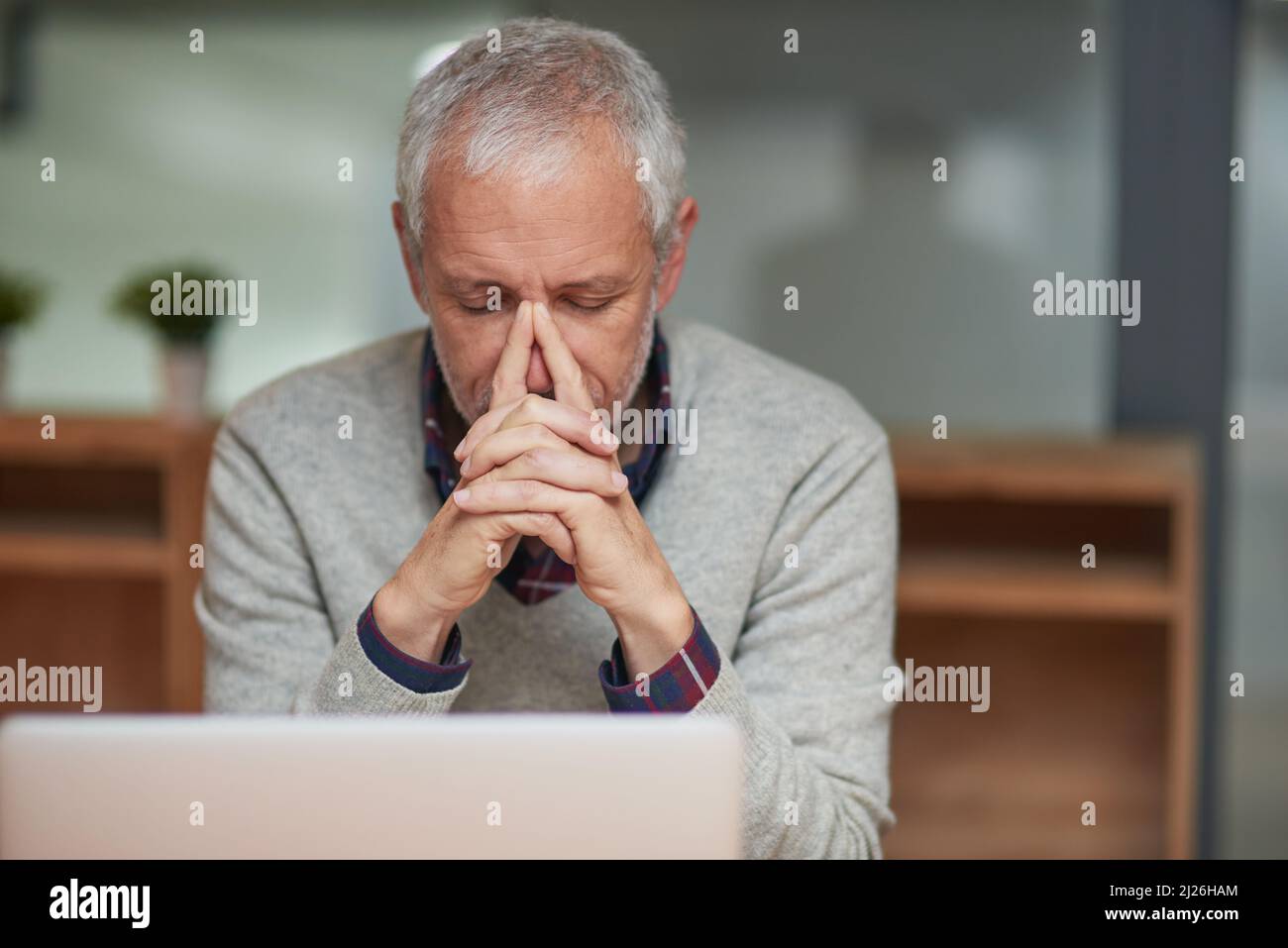 The pressure is getting to him. Shot of a stressed out mature ...