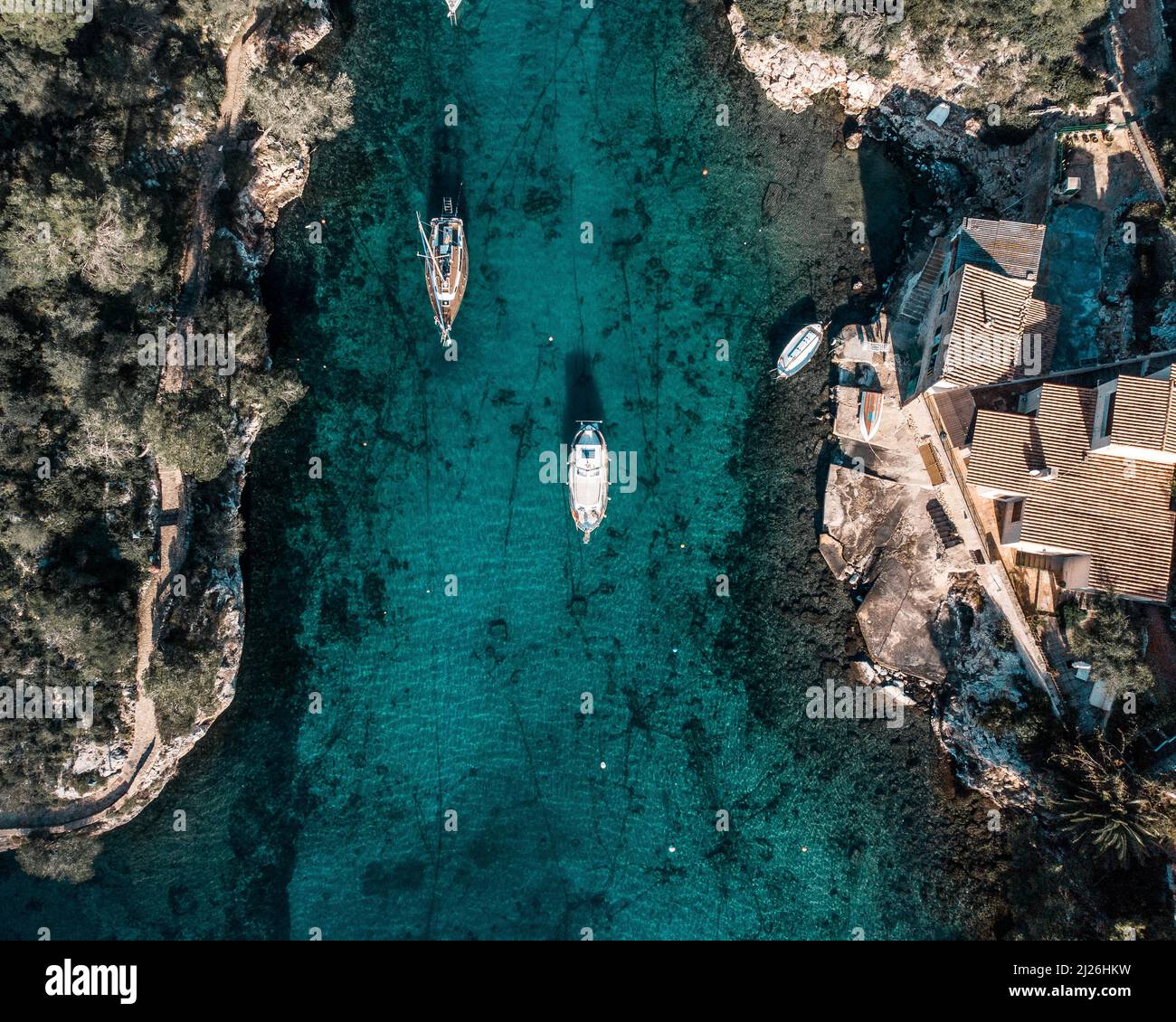 A scenic aerial view of boats and geological formations at the seashore ...