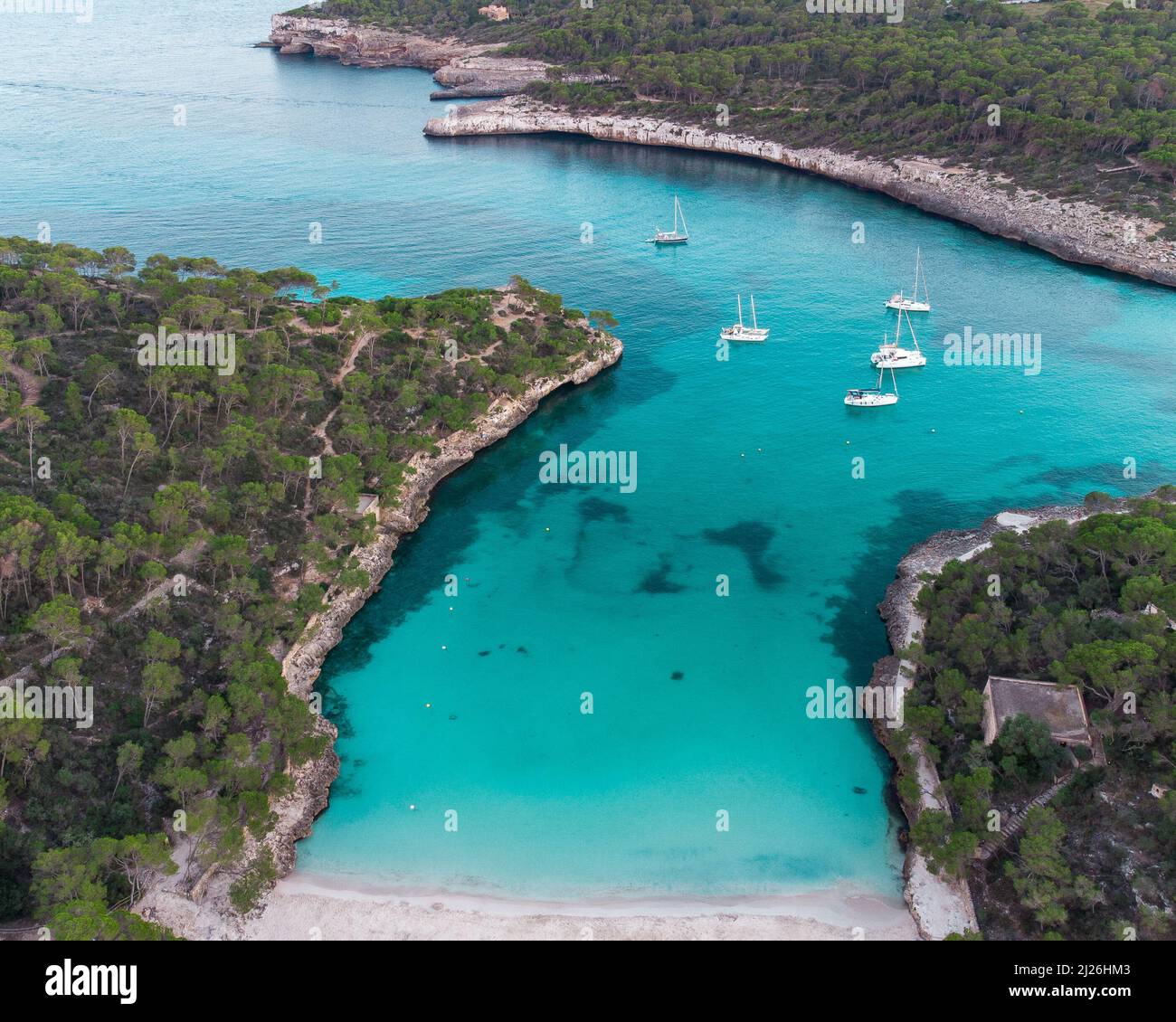 A scenic aerial view of boats and geological formations at the seashore ...