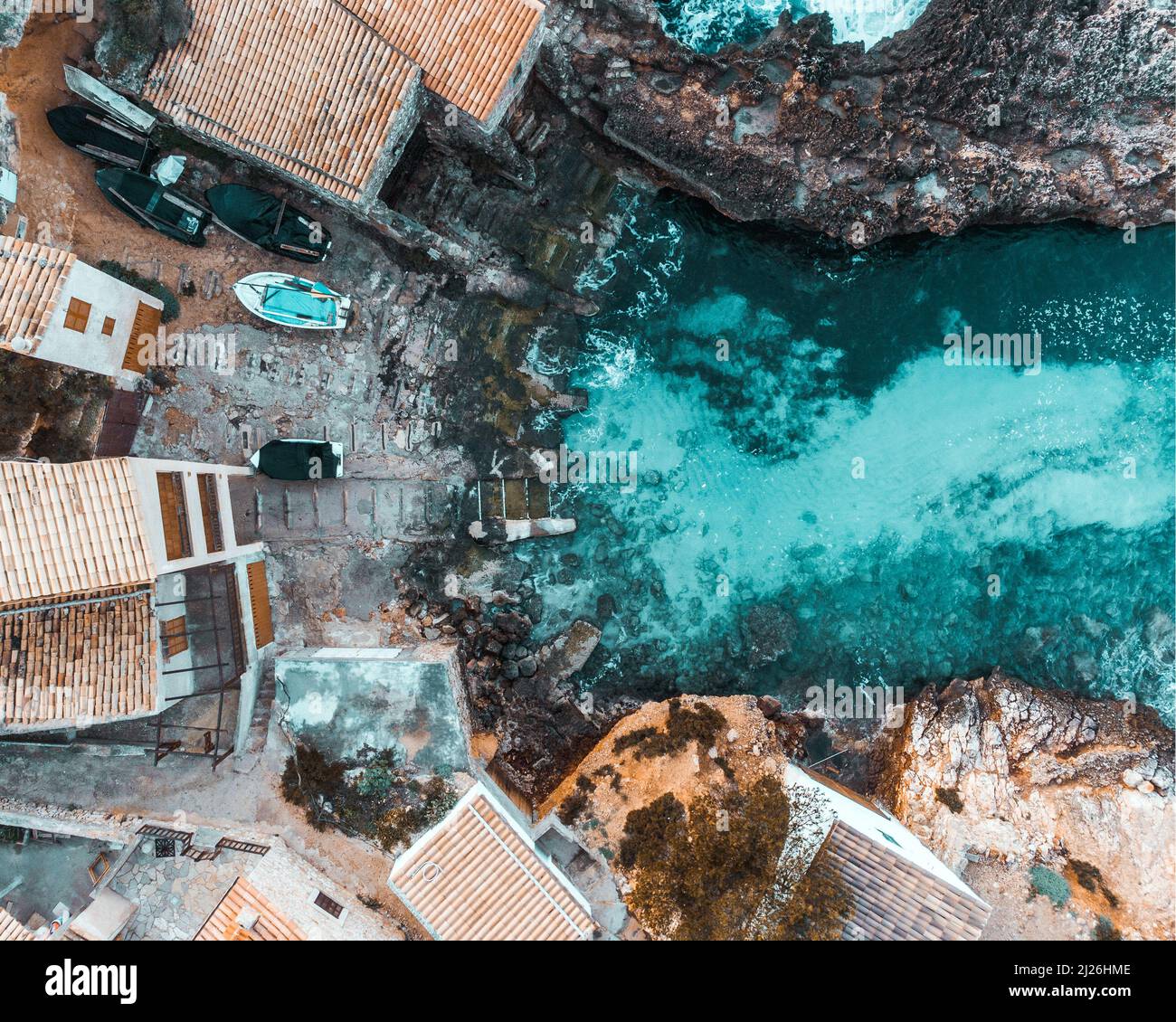 A scenic aerial view of boats and geological formations at the seashore ...