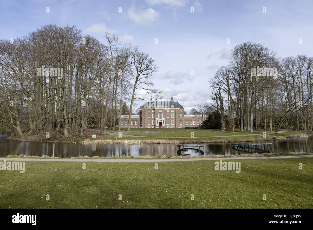 Winter barren trees on a sunny day with park and moat in the foreground ...