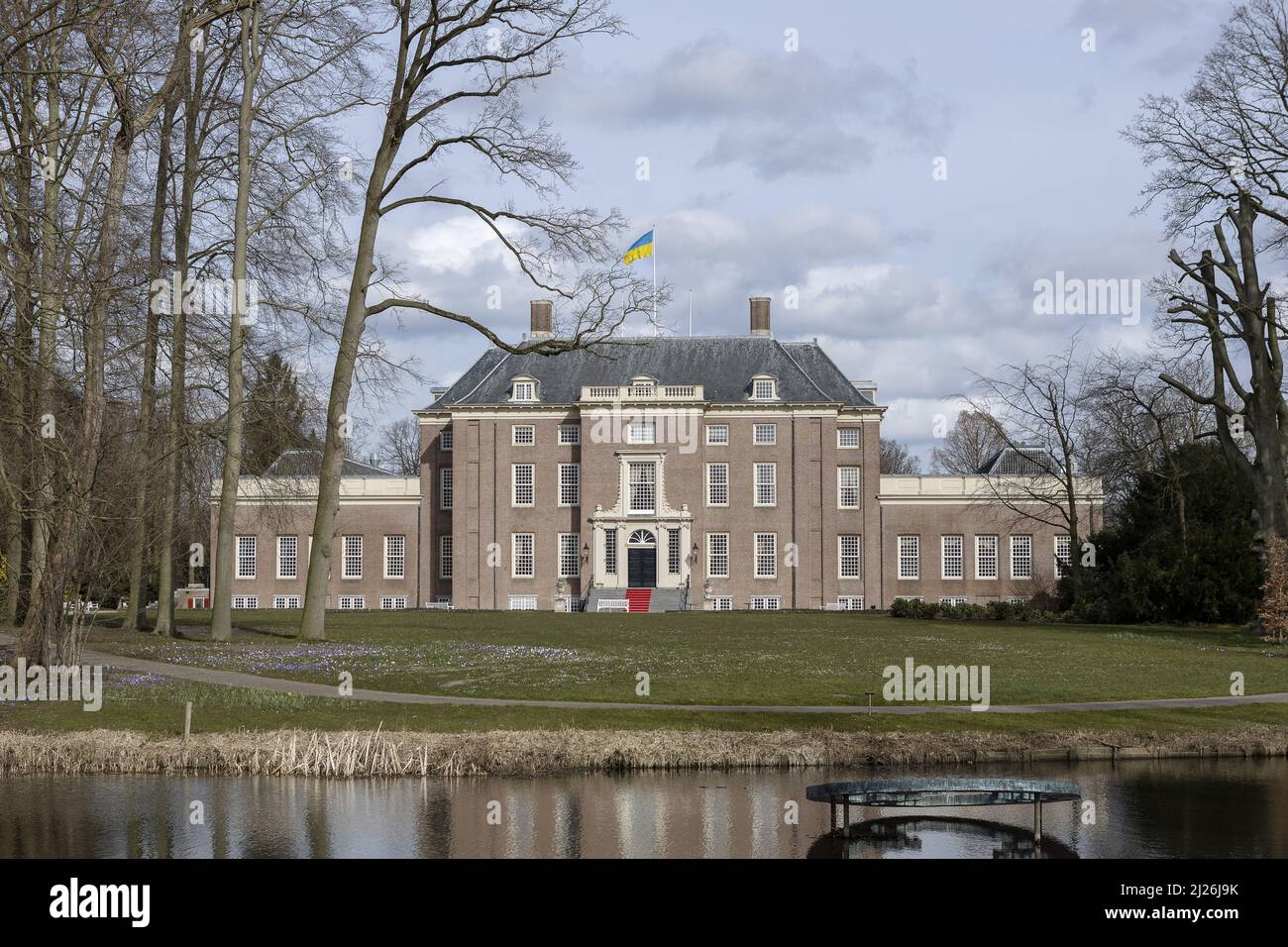 Exterior facade of Slot Zeist castle behind winter barren trees on a ...