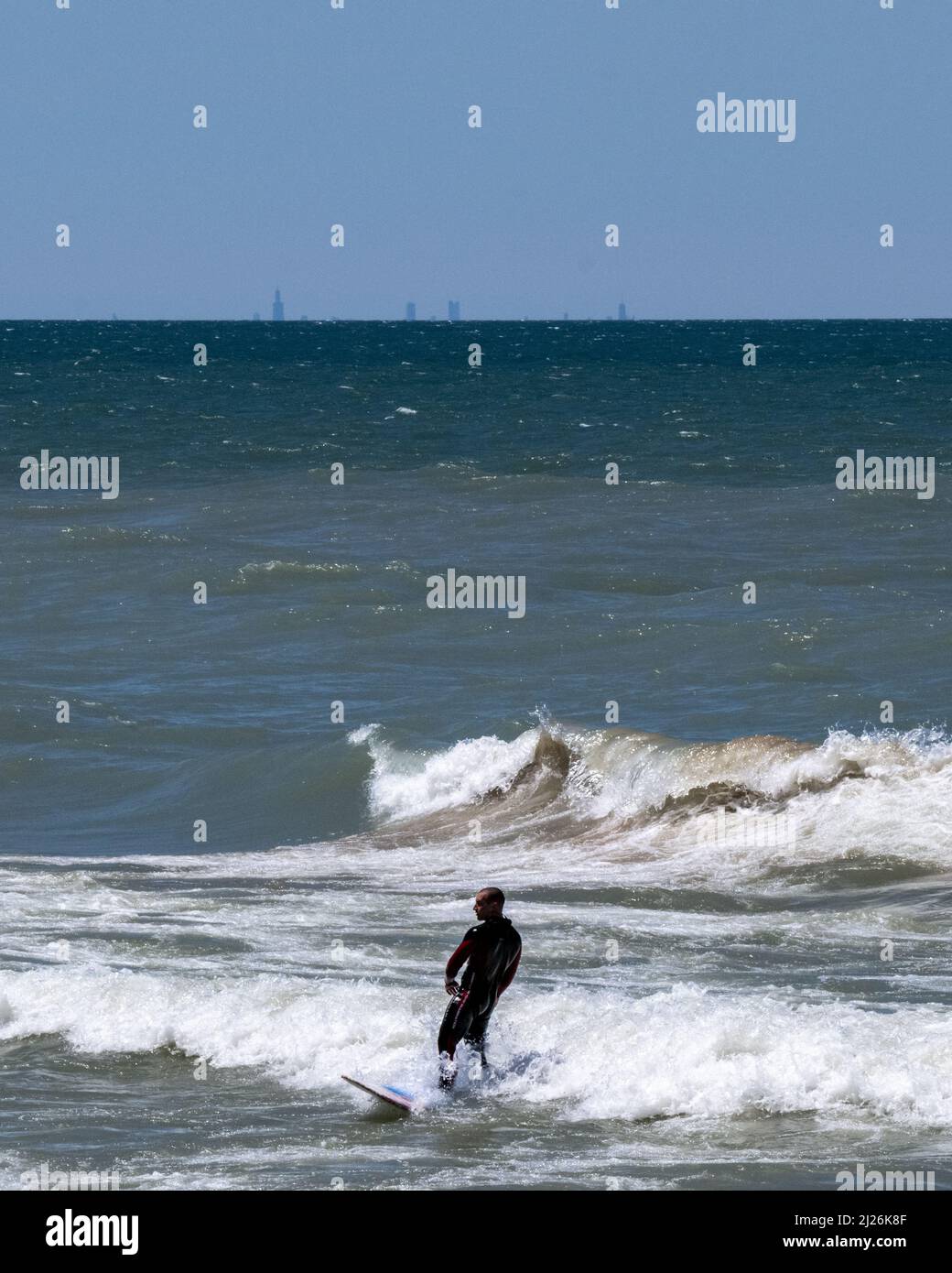 A vertical shot of a surfer on Lake Michigan in Michiana Stock Photo ...