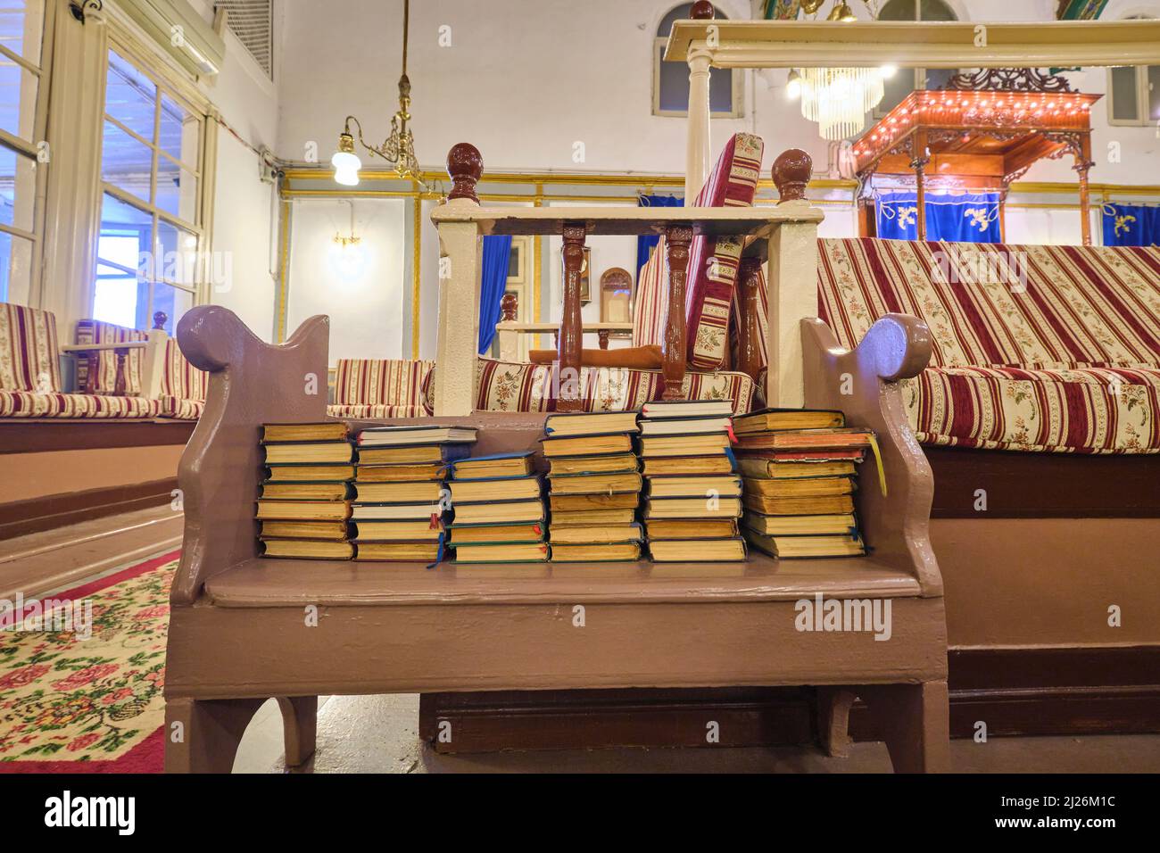 Various prayer, torah, bible, holy books stacked on a bench at the ...