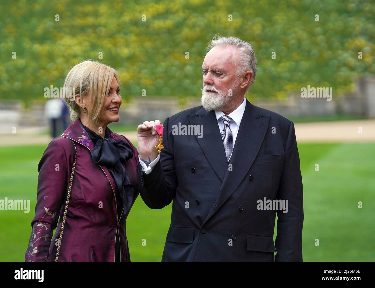 Queen drummer Roger Taylor with his wife Sarina, after being made an ...