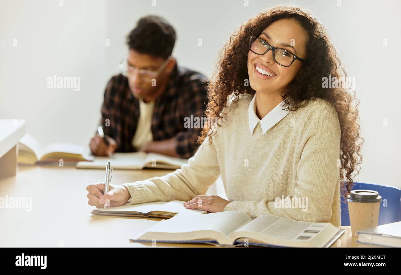 Taking notes. Cropped portrait of an attractive young female college ...