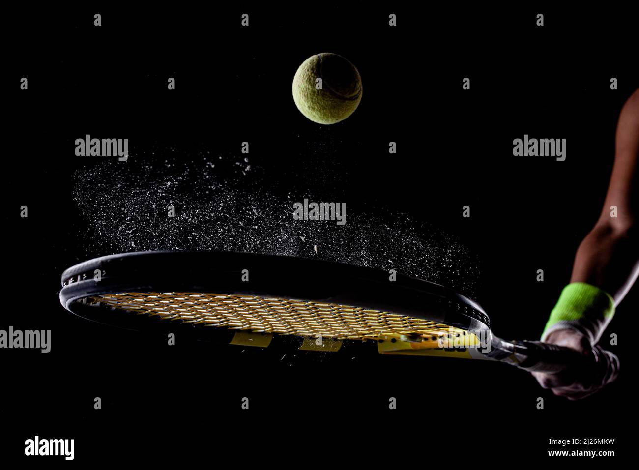 Tennis ball bouncing on racket. Dirt or magnesium dust dots visible in ...