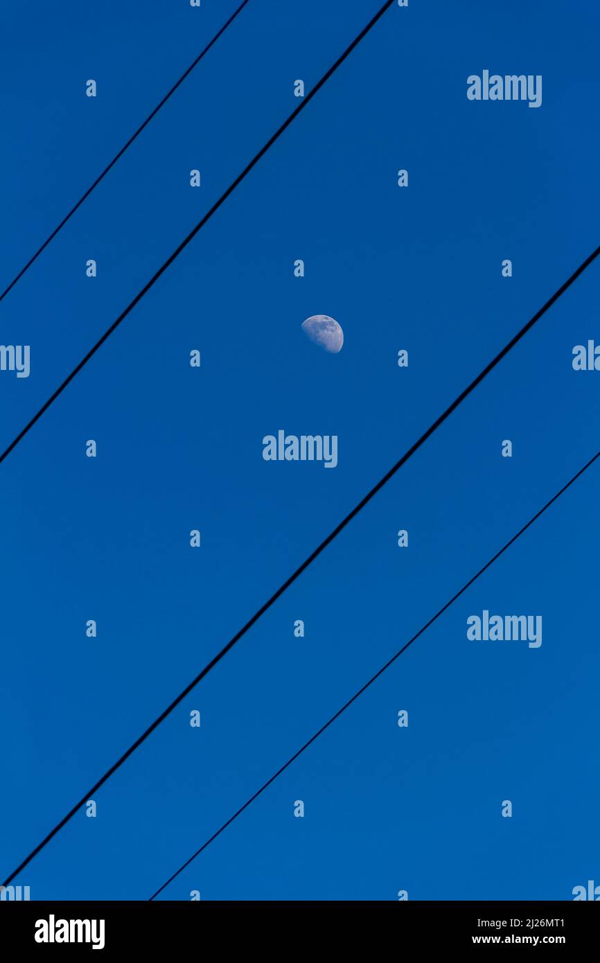 Big white moon between power lines Stock Photo - Alamy