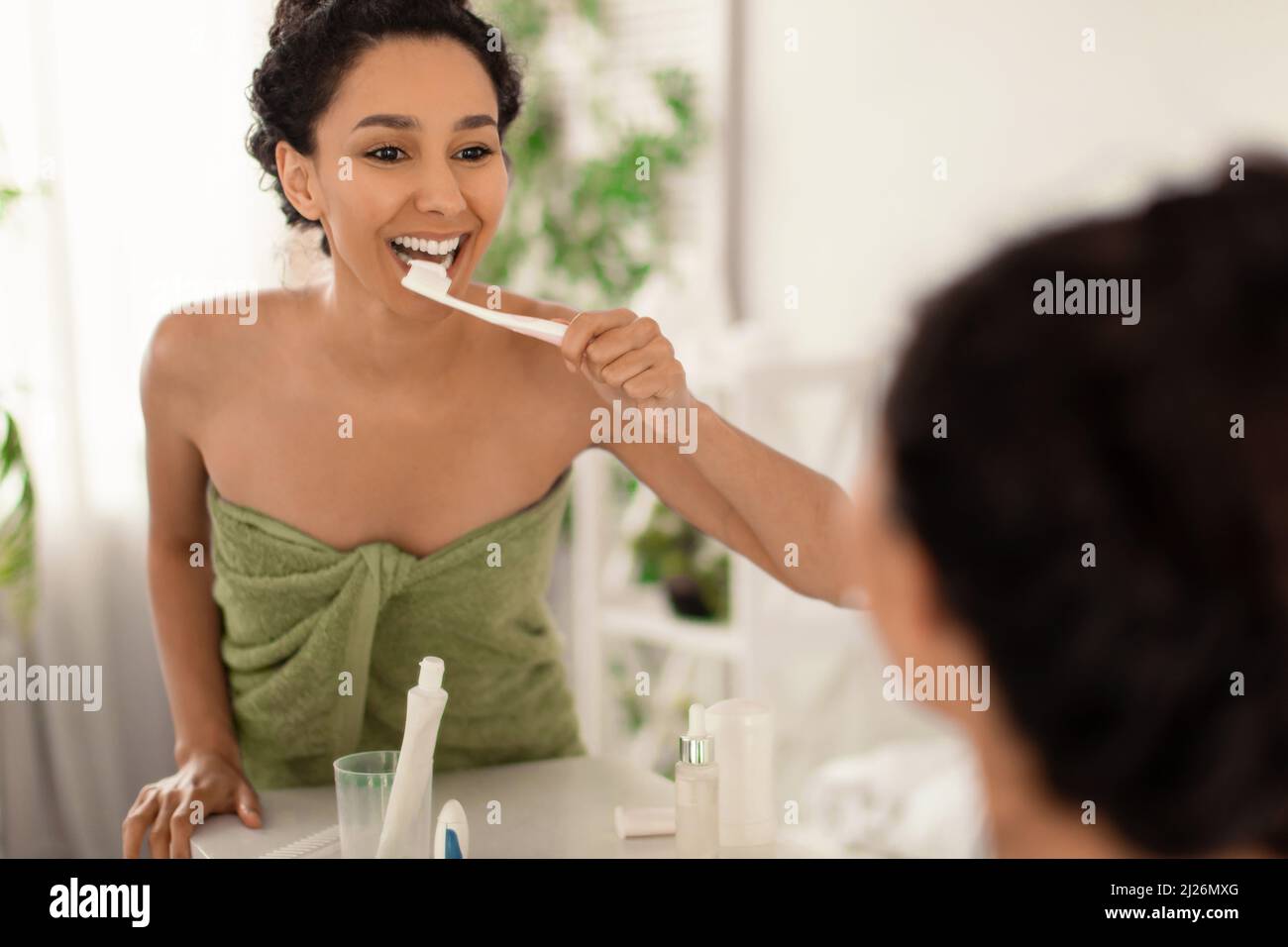 Stomatology, dental hygiene concept. Pretty young lady in towel ...