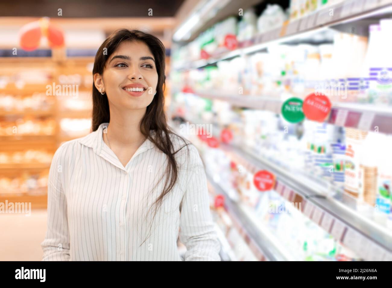 Portrait Of Happy Arabic Female Customer Standing In Supermarket Stock ...