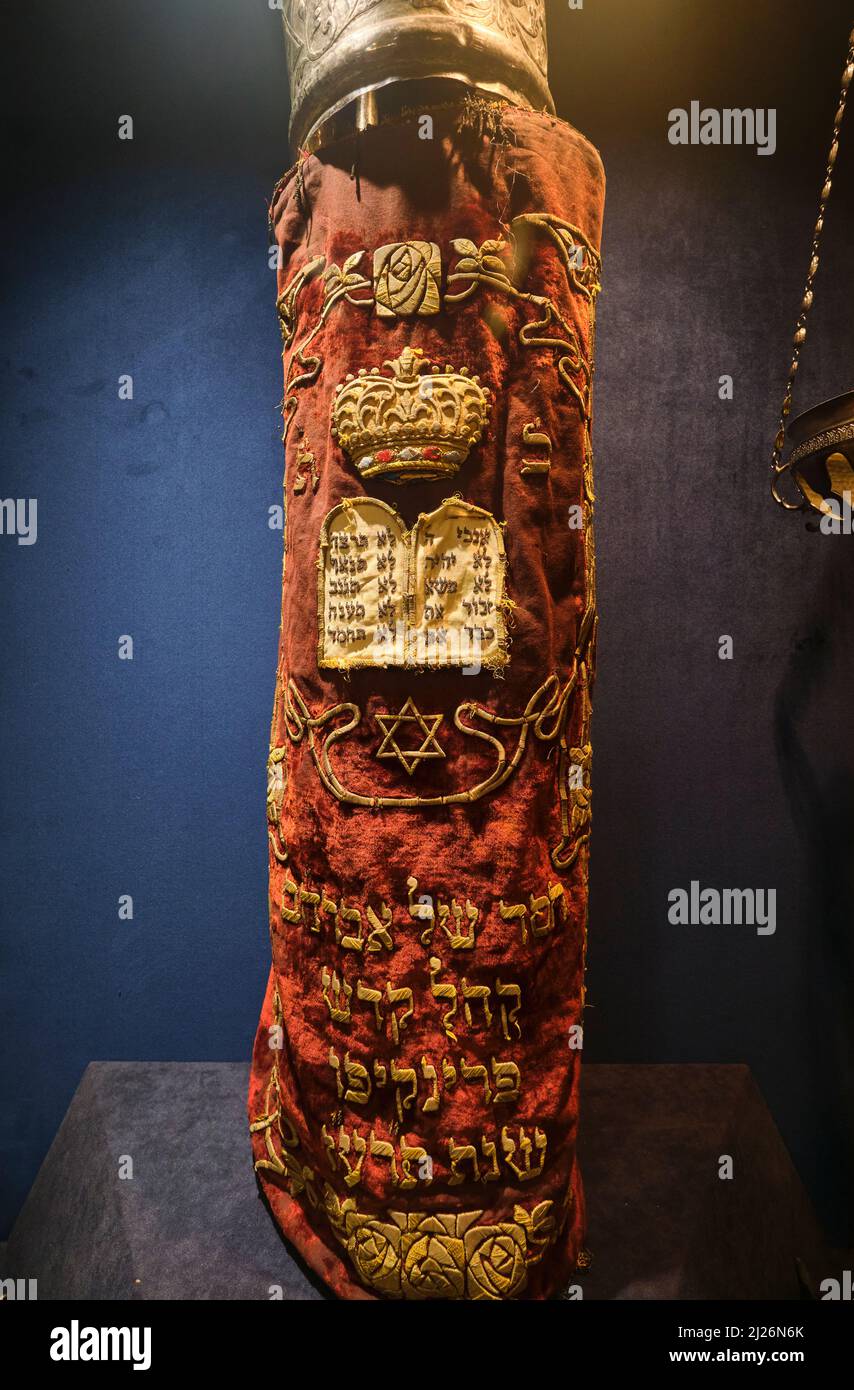 A display of a red velvet cloth, textile torah cover with the ten ...
