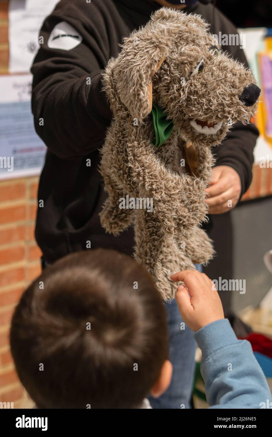 unrecognizable child looking at a stuffed dog puppet Stock Photo - Alamy