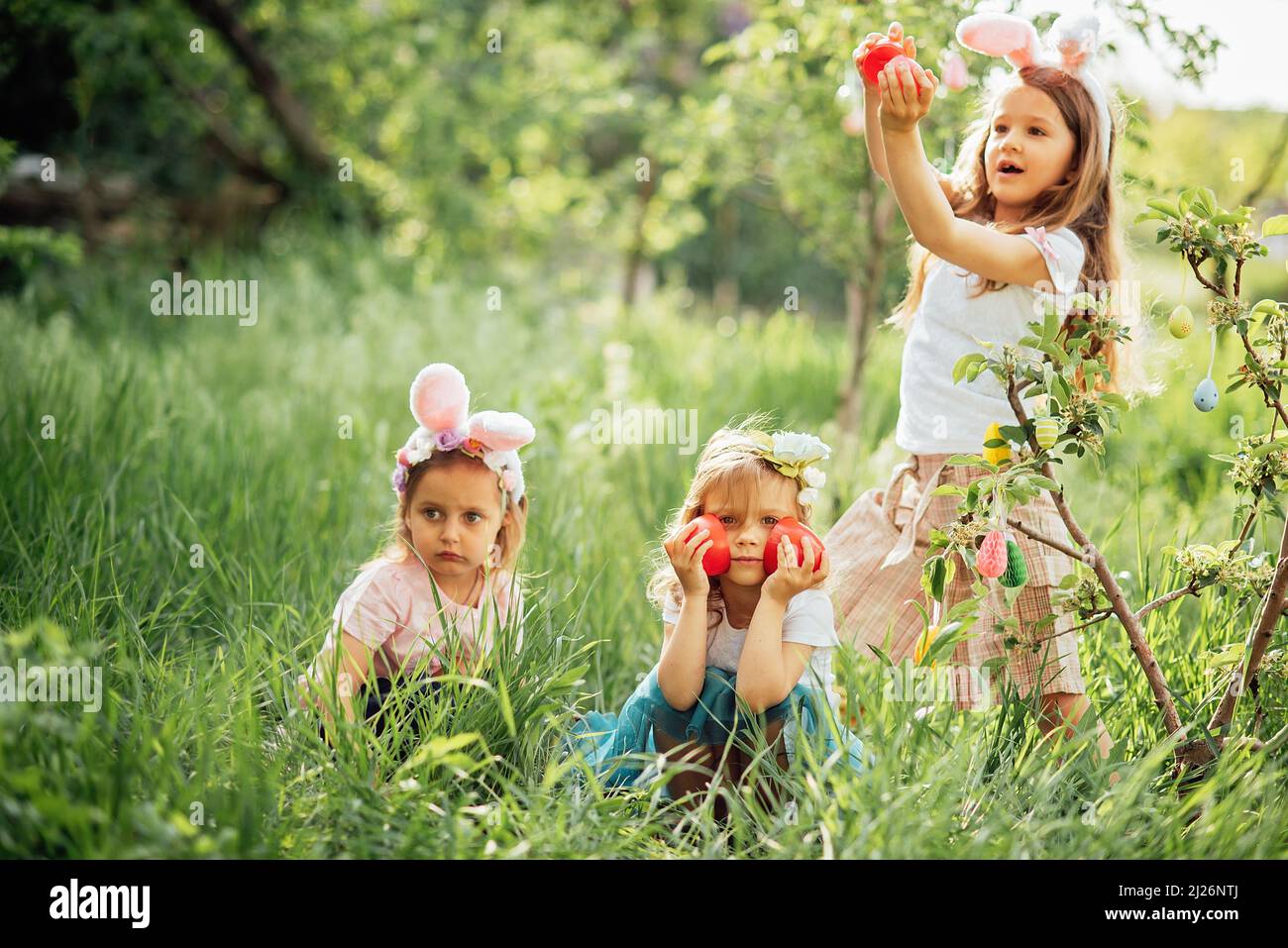 Easter egg hunt. Group Of Children Wearing Bunny Ears Running To Pick ...