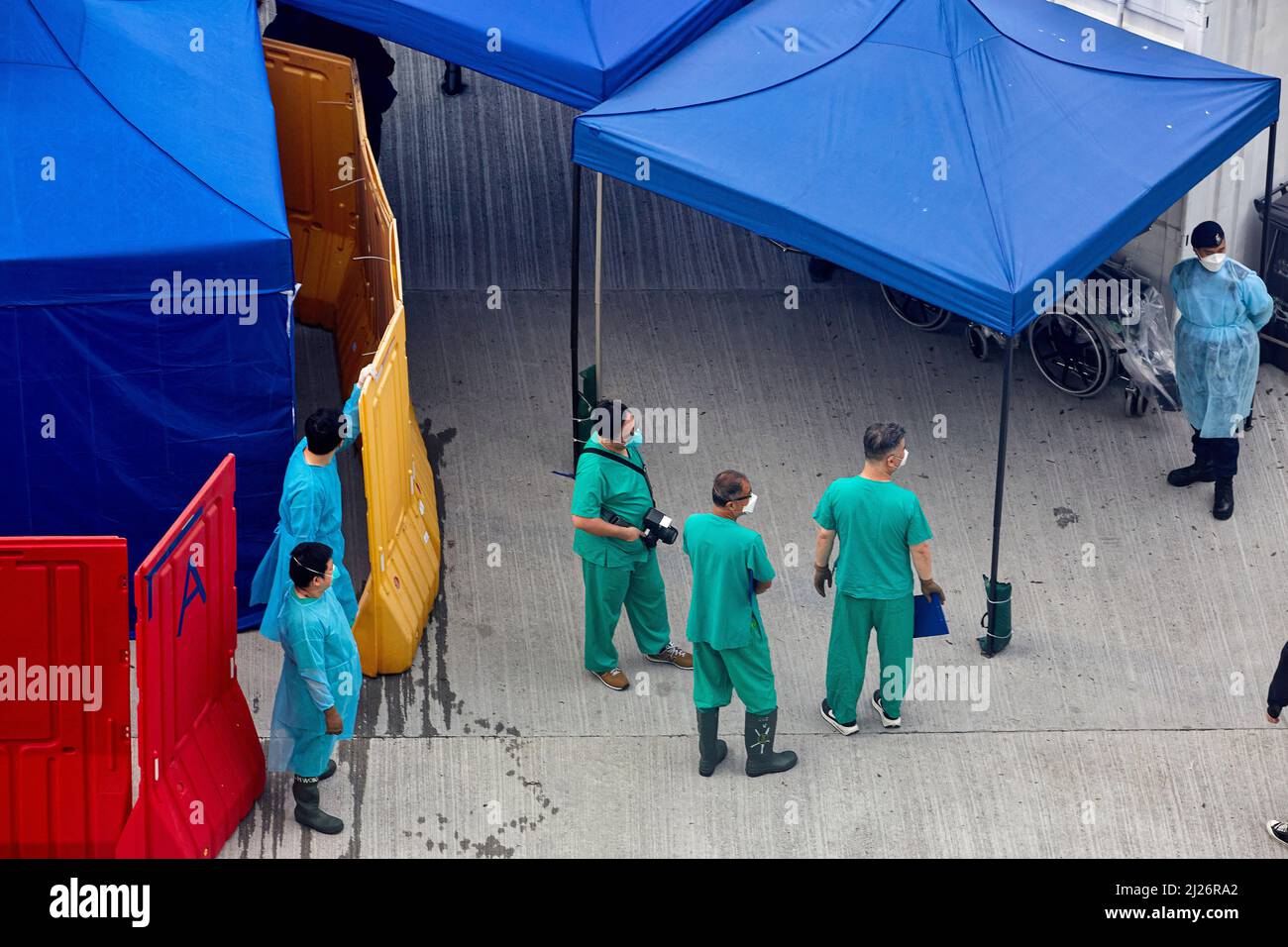 Funeral employees prepare to remove a body from a refrigerated ...