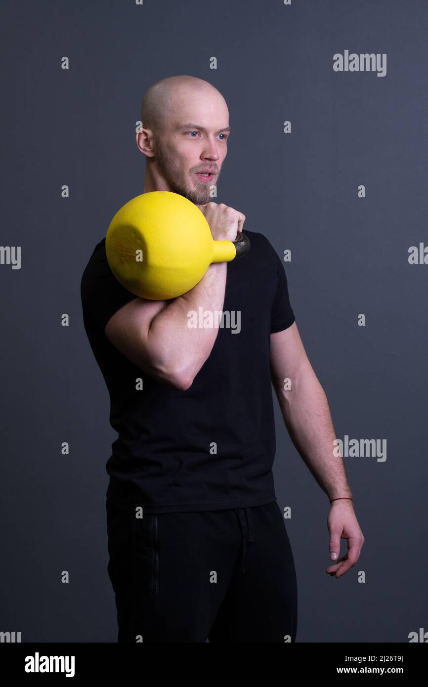 Guy with a yellow kettlebell gym anonymous yellow man, in the afternoon ...