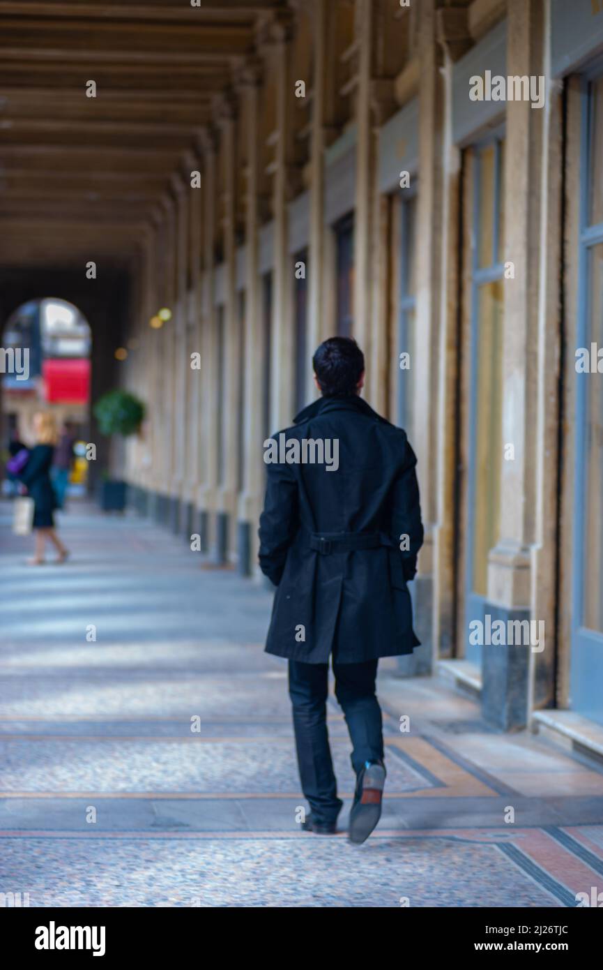 Paris, France, Young Man from Behind, Walking Away in Arches of Palais ...