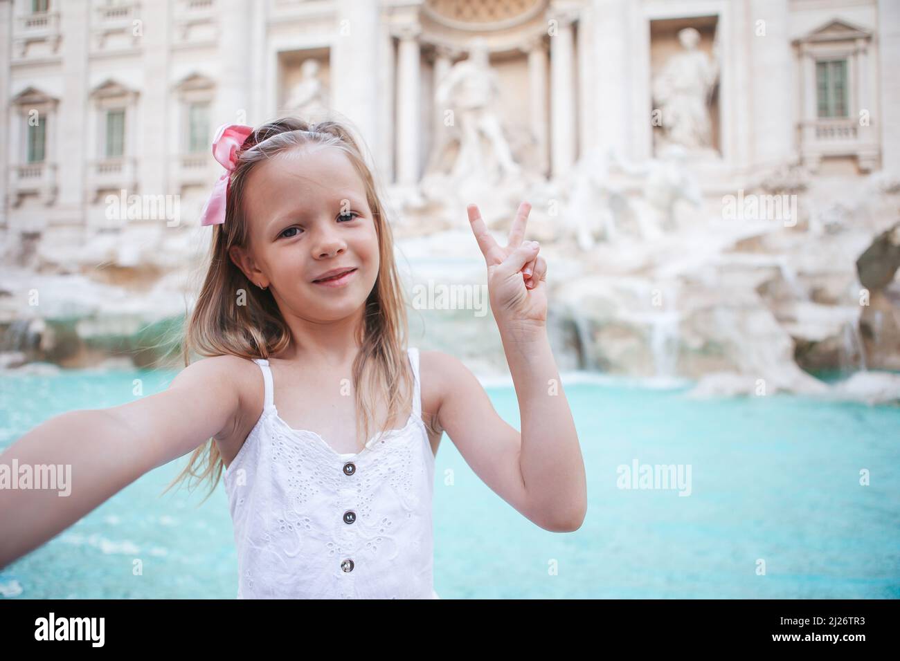 Adorable little girl background Trevi Fountain, Rome, Italy. Happy ...