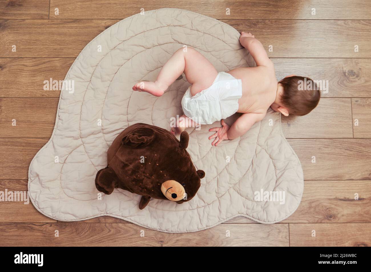 Falling infant baby boy in diapers while crawling or walking. Child ...