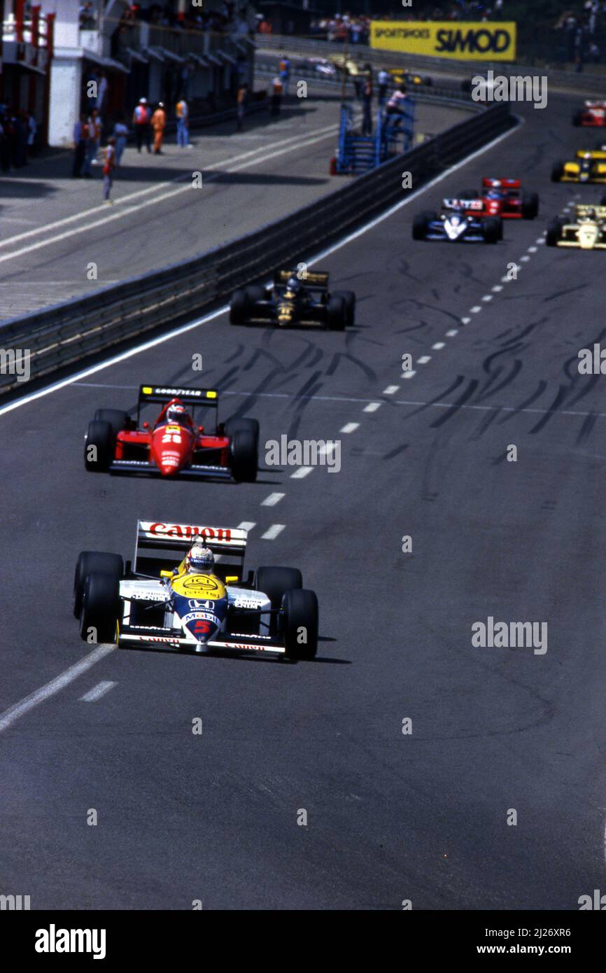Nigel Mansell (GBR) Williams FW11 Honda 1st position leads Stefan ...